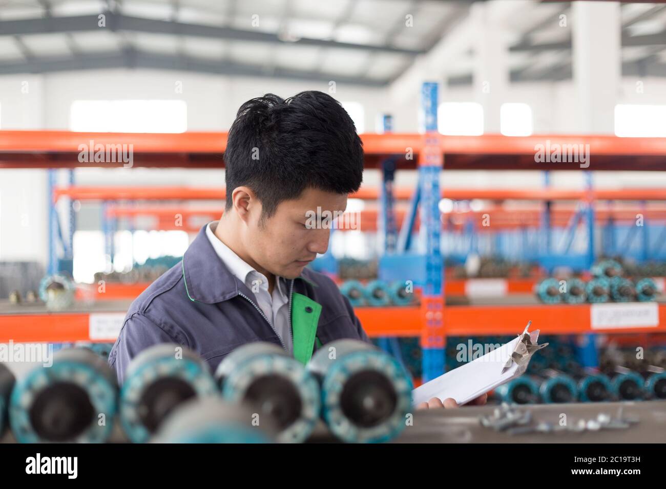 young asian man works in workshop Stock Photo - Alamy