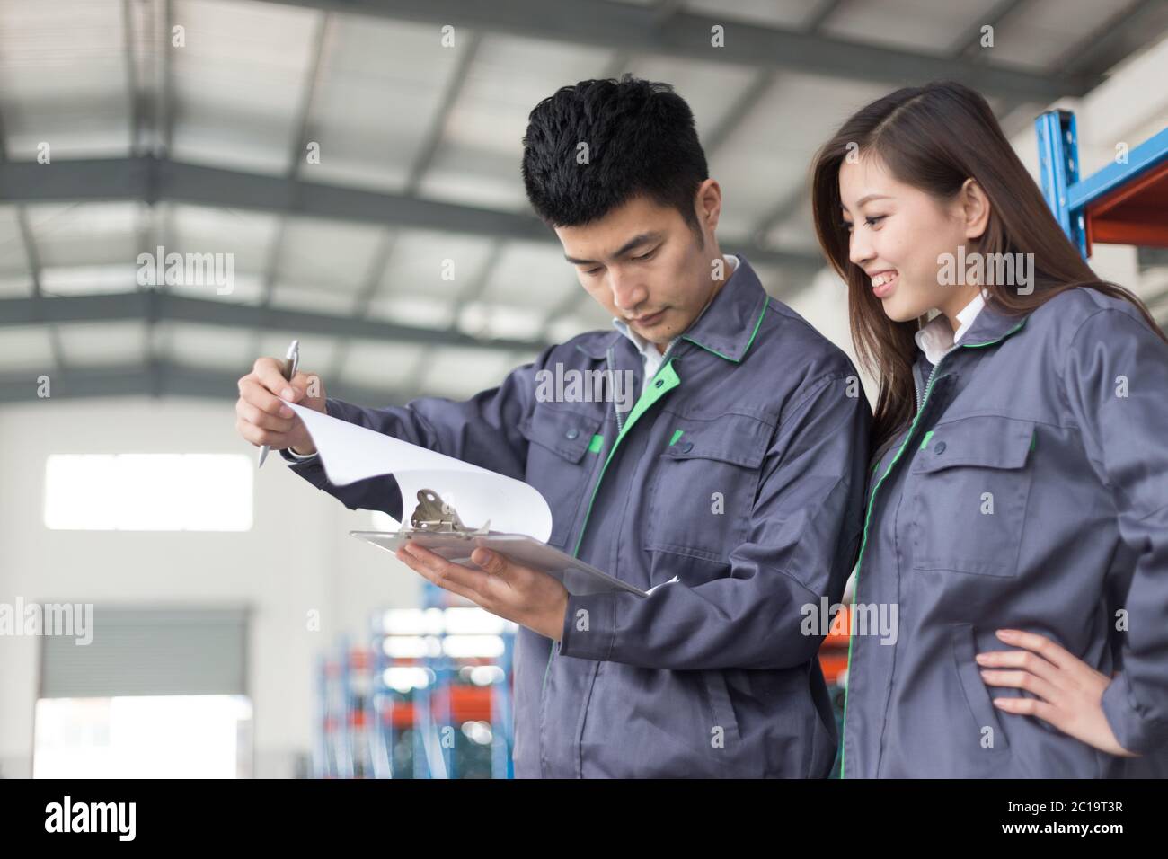 young asian man and woman work in workshop Stock Photo - Alamy