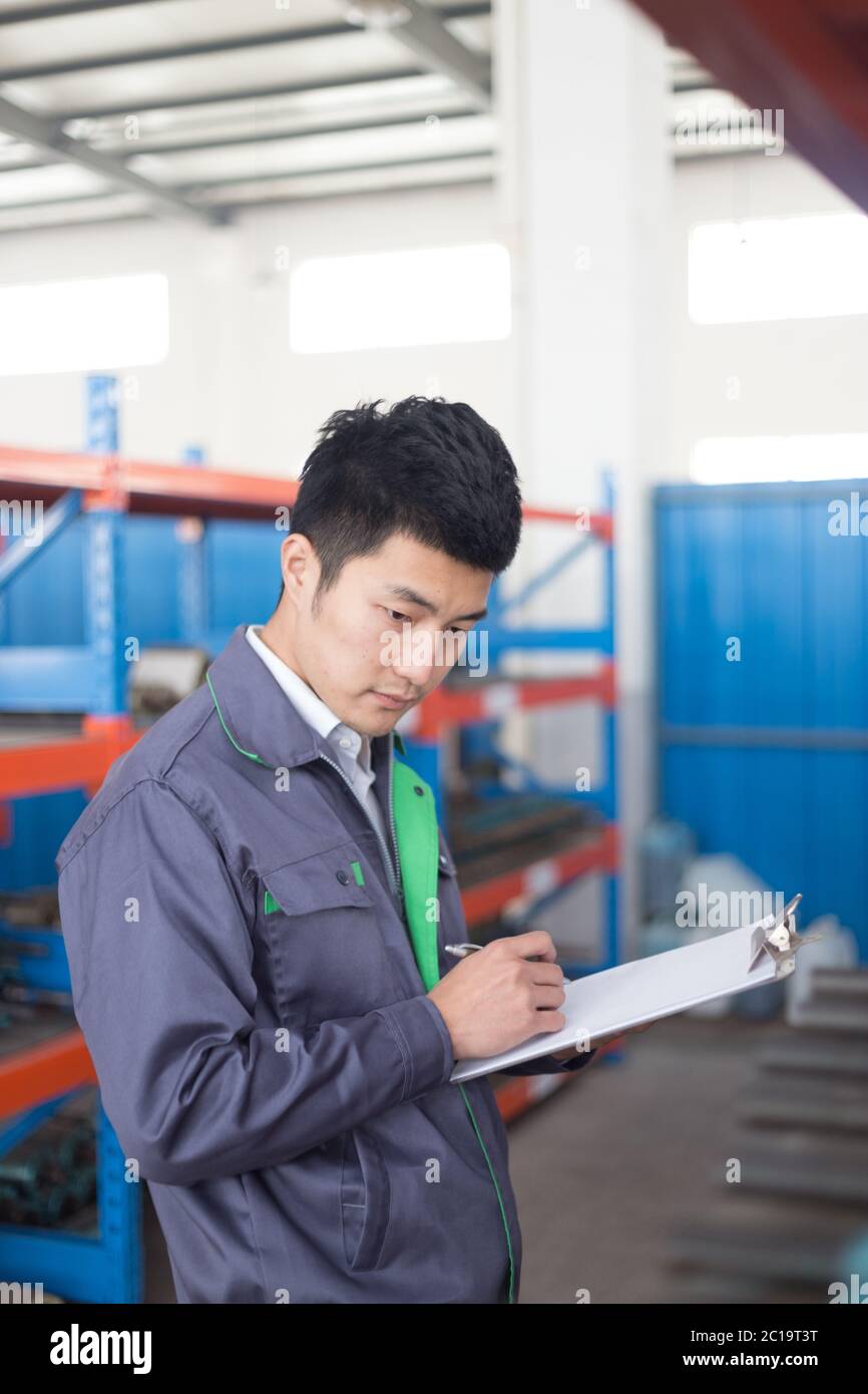 young asian man works in workshop Stock Photo - Alamy