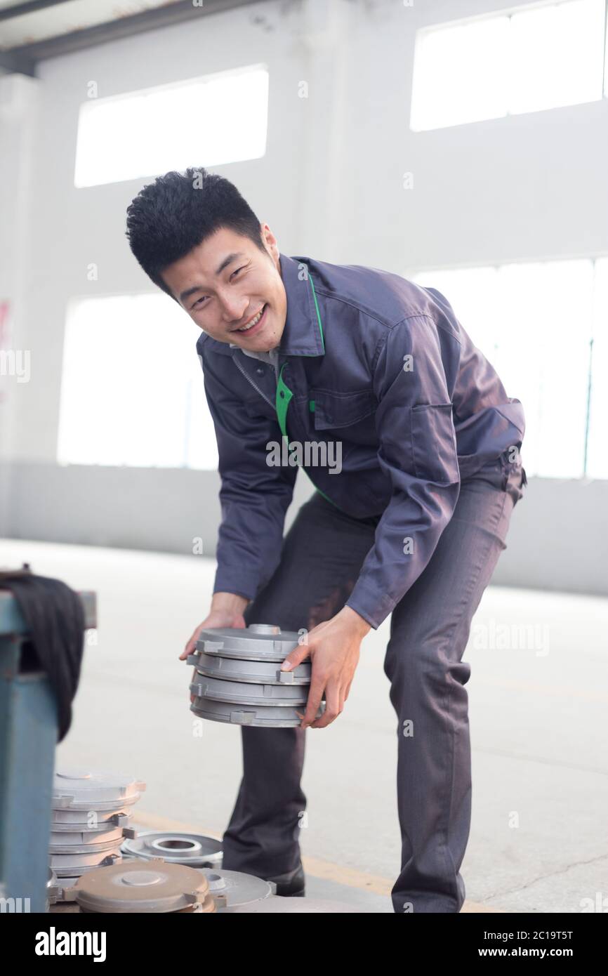 young asian man works in workshop Stock Photo - Alamy