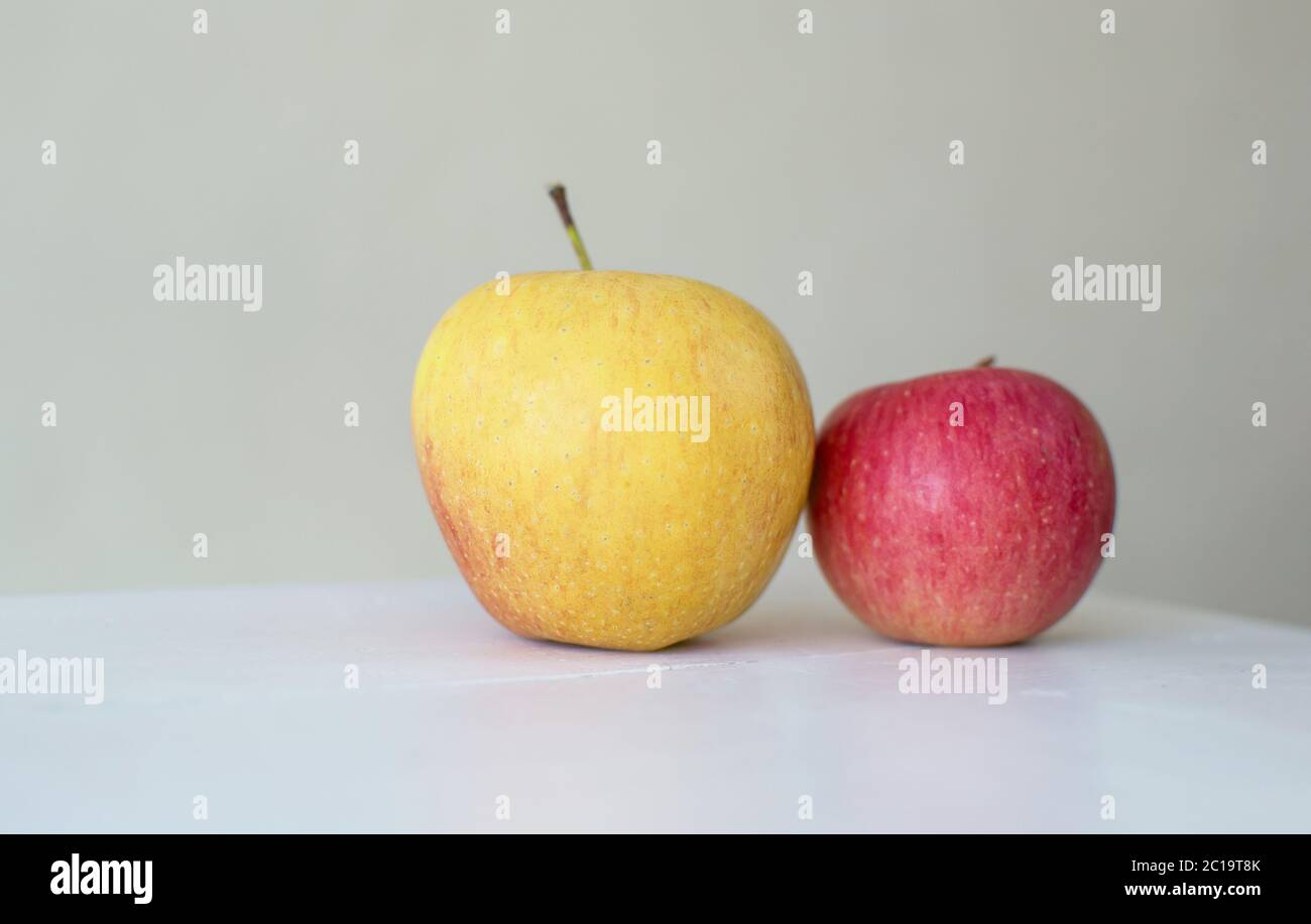 big and small red apples isolated on white wood table close up Stock ...
