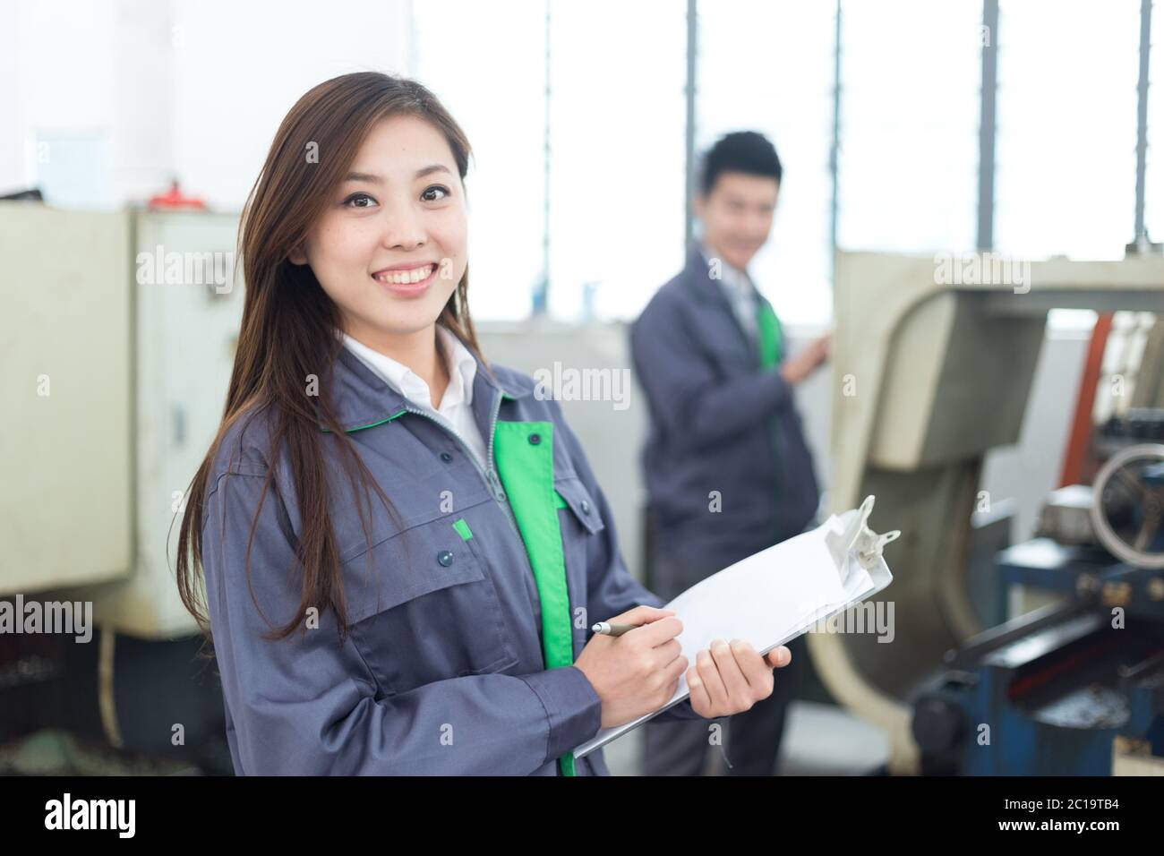 young asian woman works in workshop Stock Photo - Alamy