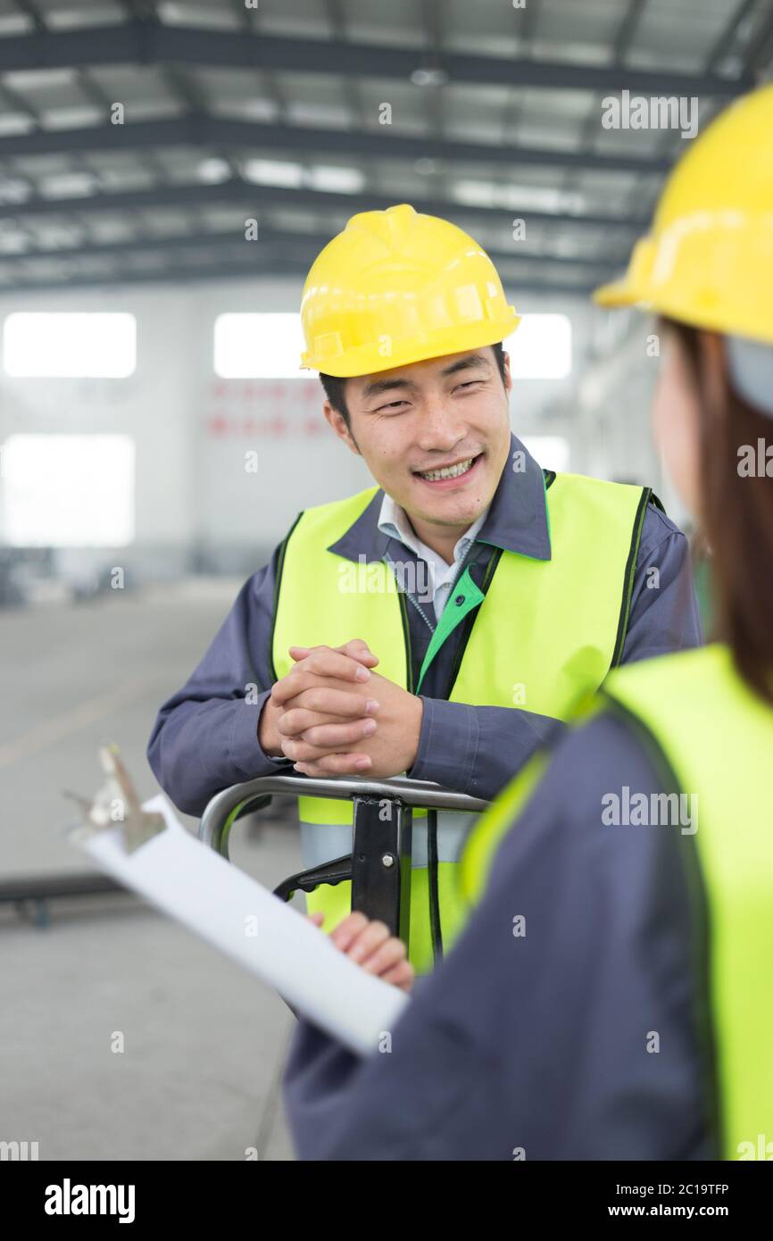 young asian man and woman work in workshop Stock Photo - Alamy