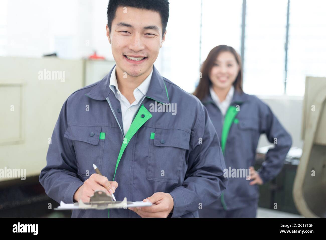 young asian man and woman work in workshop Stock Photo - Alamy