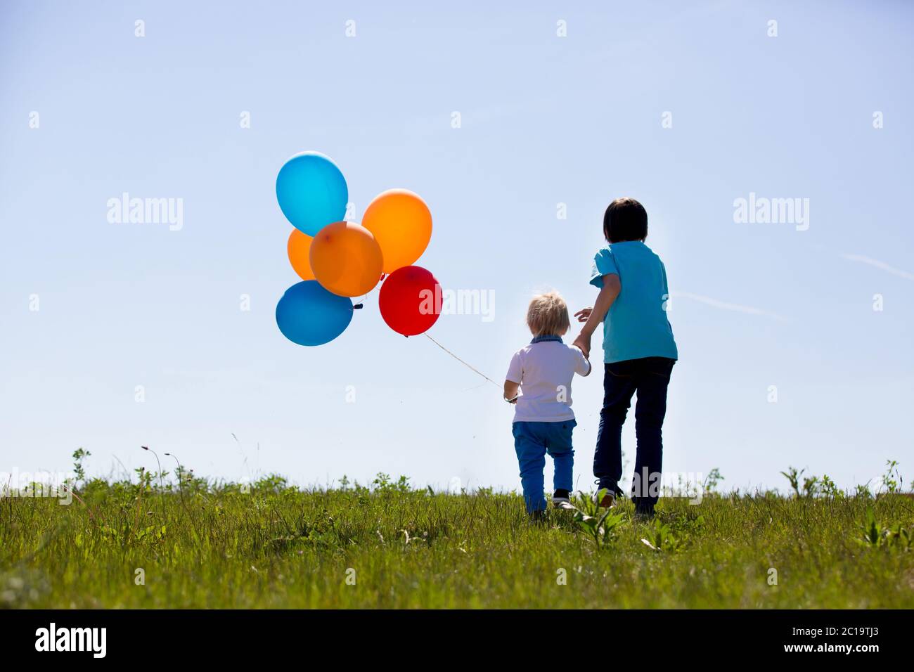 Kids playing balloons on field hi-res stock photography and images - Alamy