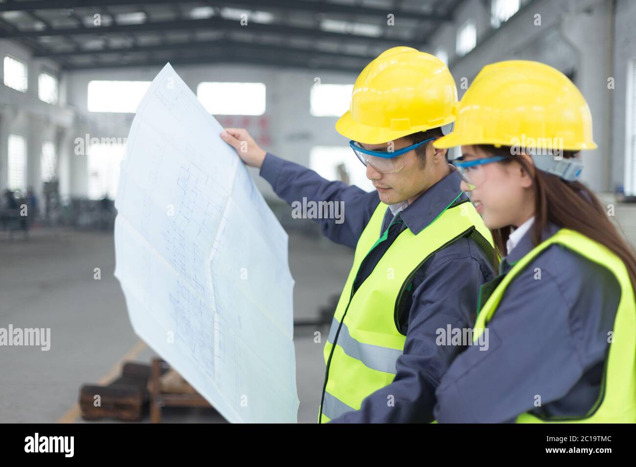 young asian man and woman work in workshop Stock Photo - Alamy