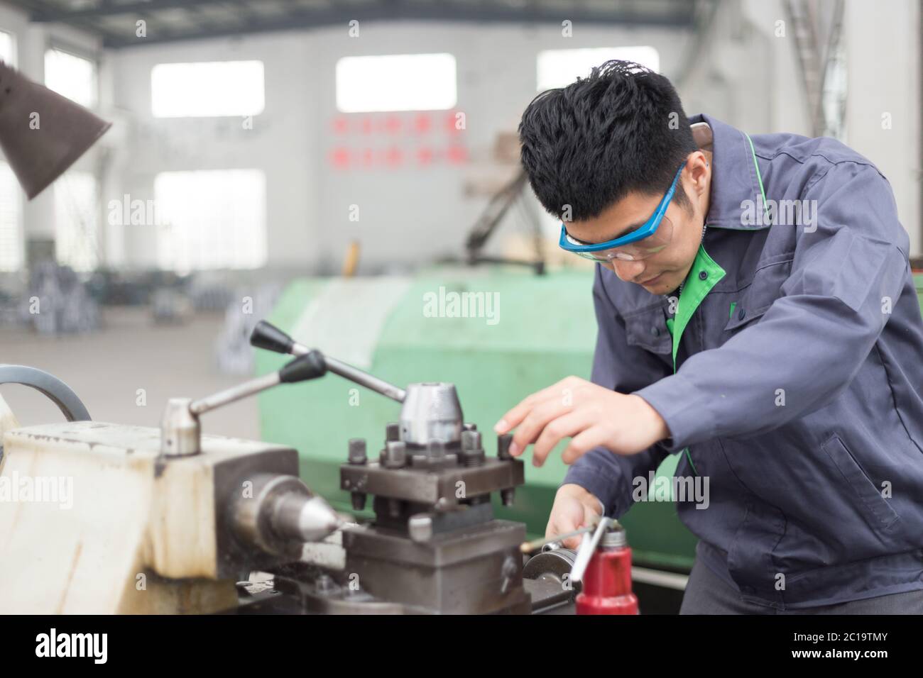 young asian man works in workshop Stock Photo - Alamy