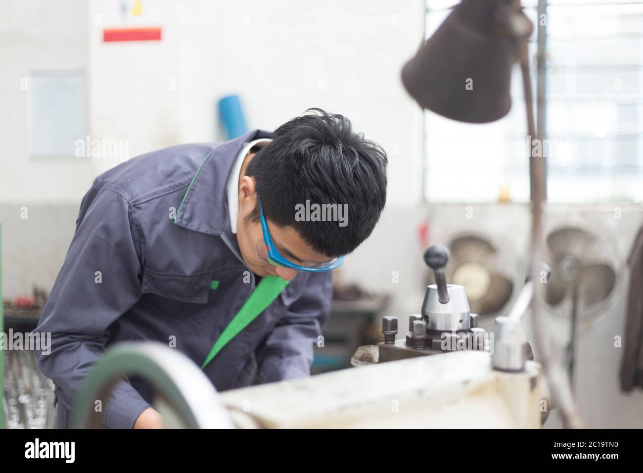 young asian man works in workshop Stock Photo - Alamy