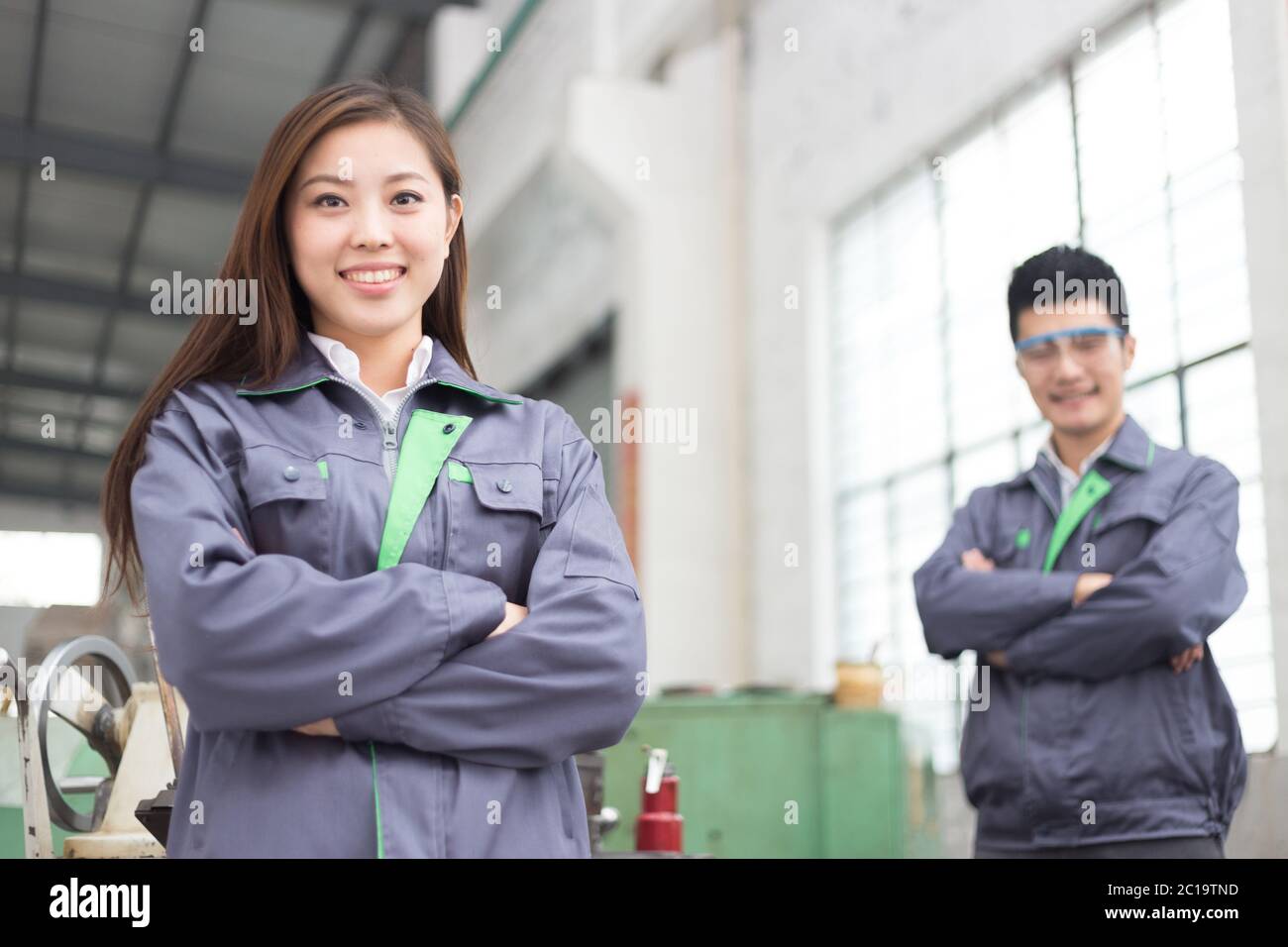 young asian man and woman work in workshop Stock Photo - Alamy