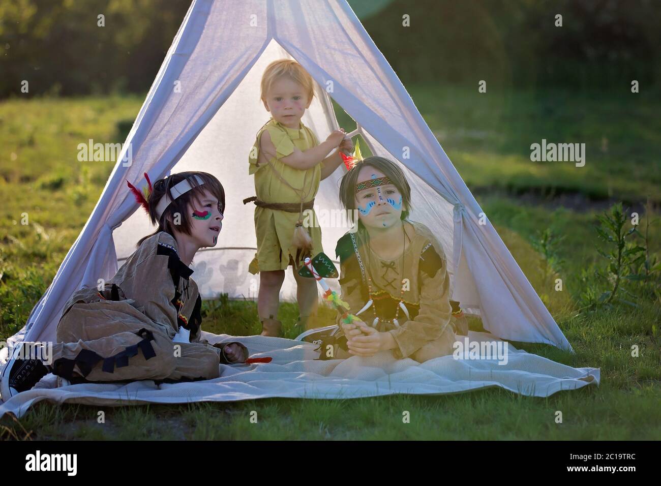Cute portrait of native american boys with costumes, playing outdoor in ...