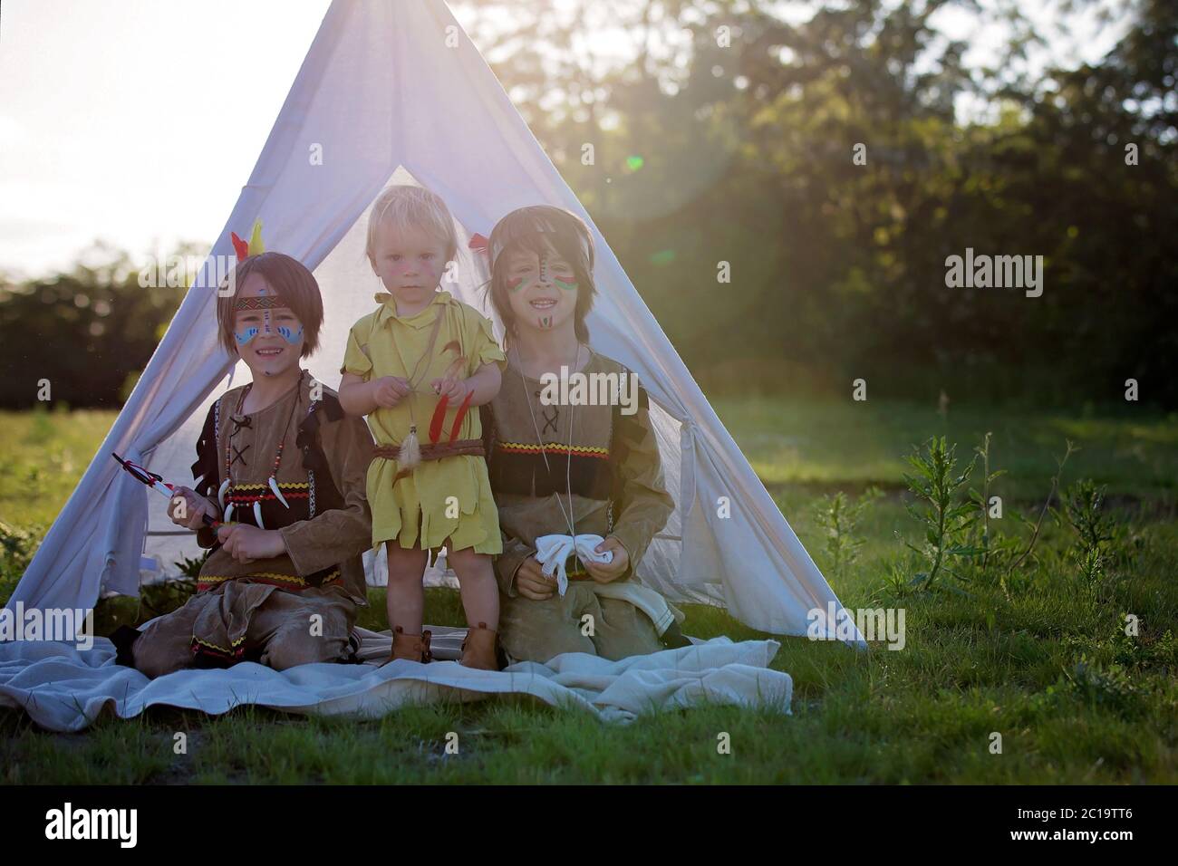 Cute portrait of native american boys with costumes, playing outdoor in ...