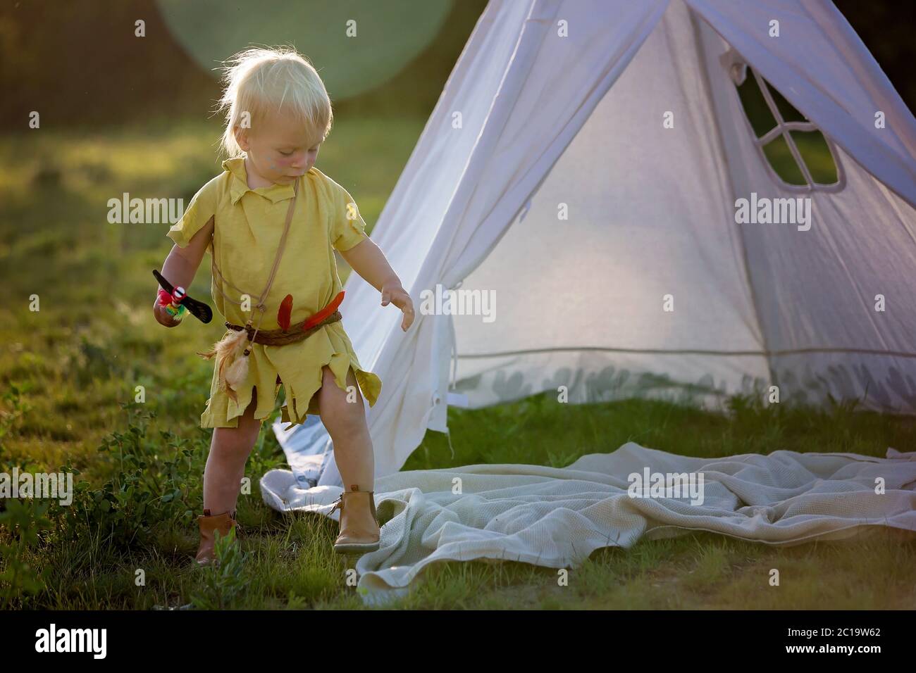 Cute portrait of native american boys with costumes, playing outdoor in ...