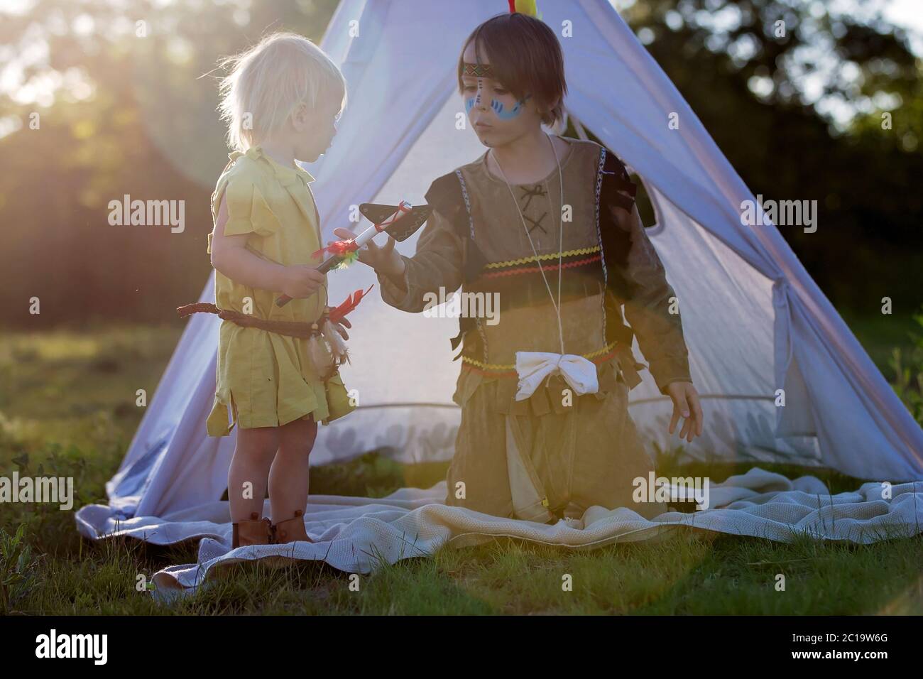 Cute portrait of native american boys with costumes, playing outdoor in ...