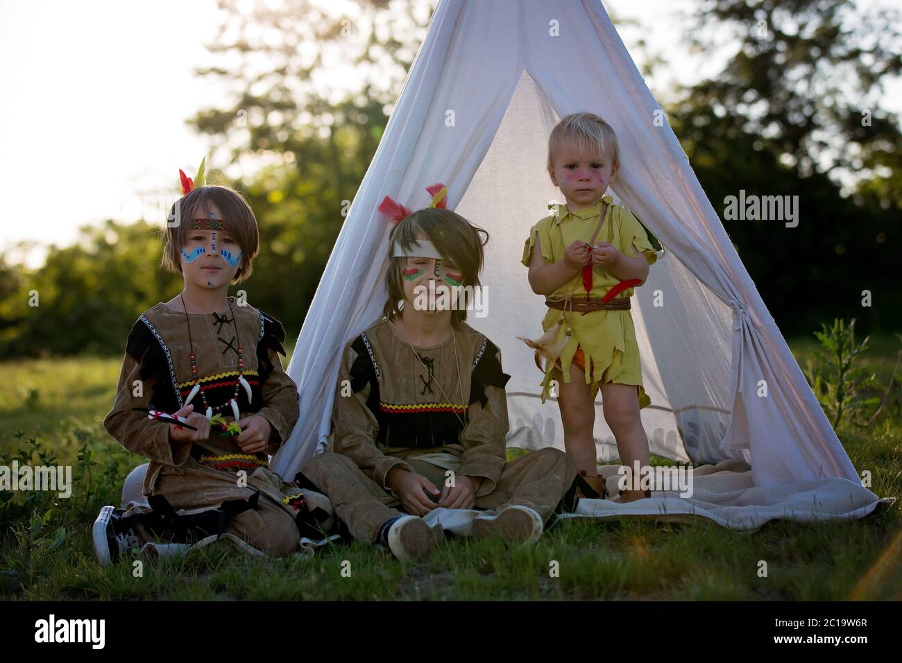 Cute portrait of native american boys with costumes, playing outdoor in ...