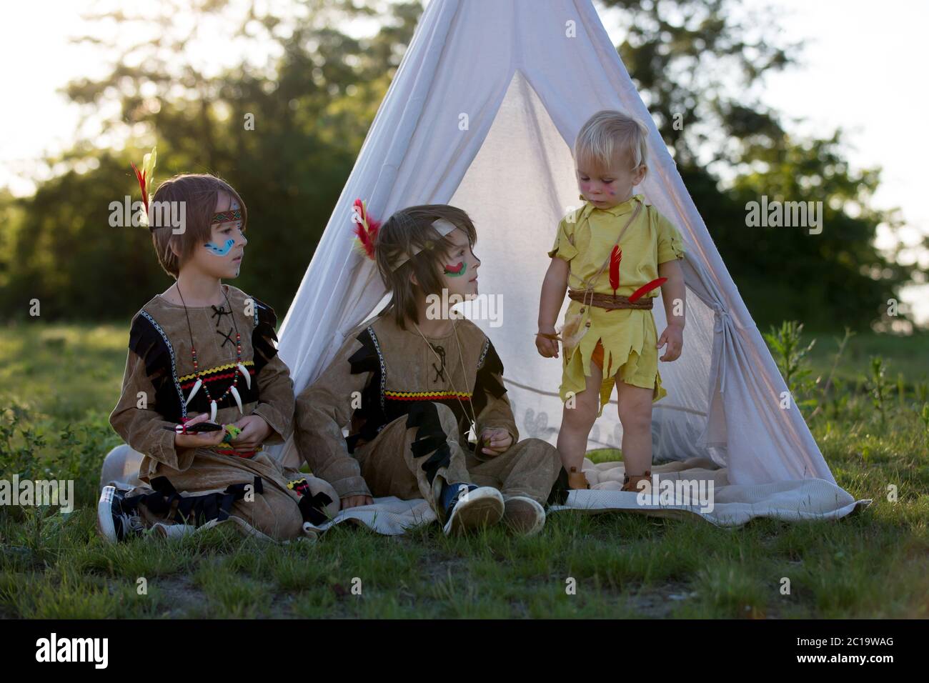 Cute portrait of native american boys with costumes, playing outdoor in ...
