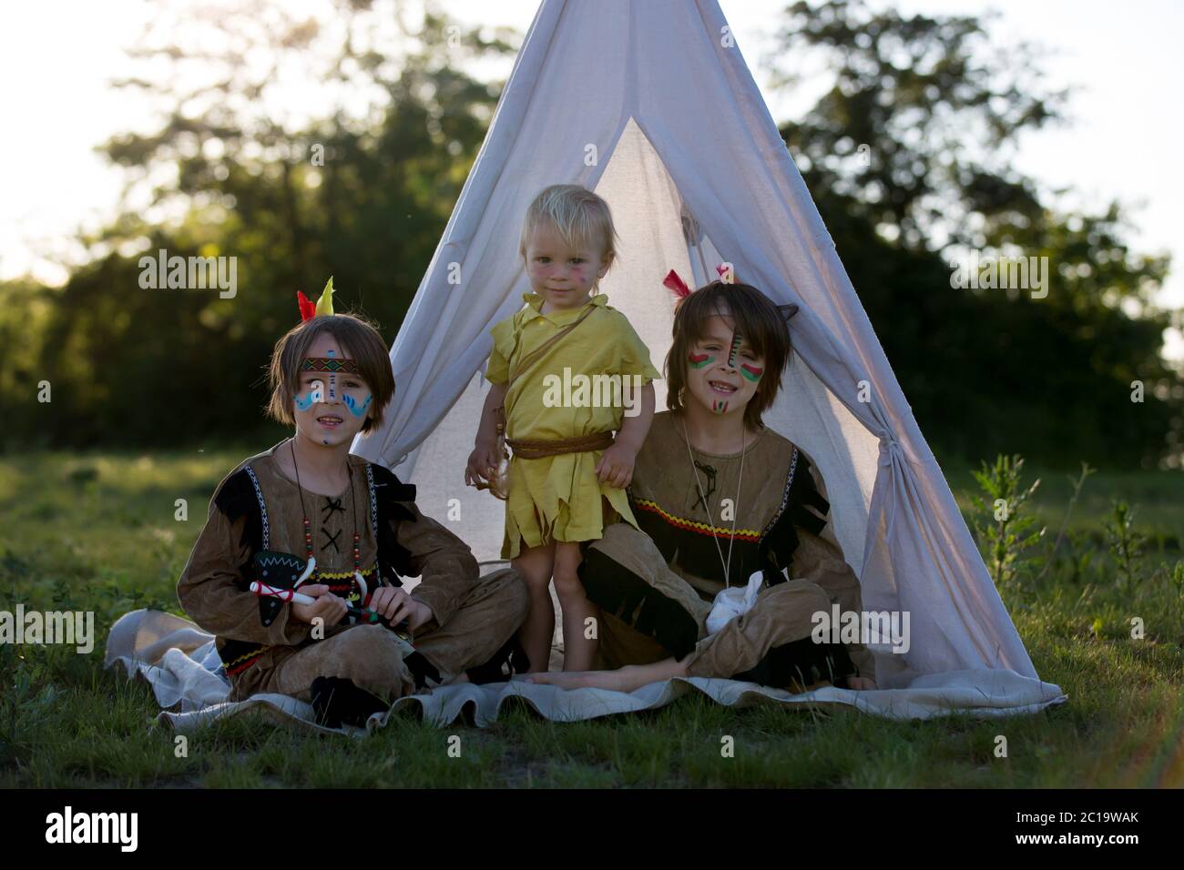 Cute portrait of native american boys with costumes, playing outdoor in ...