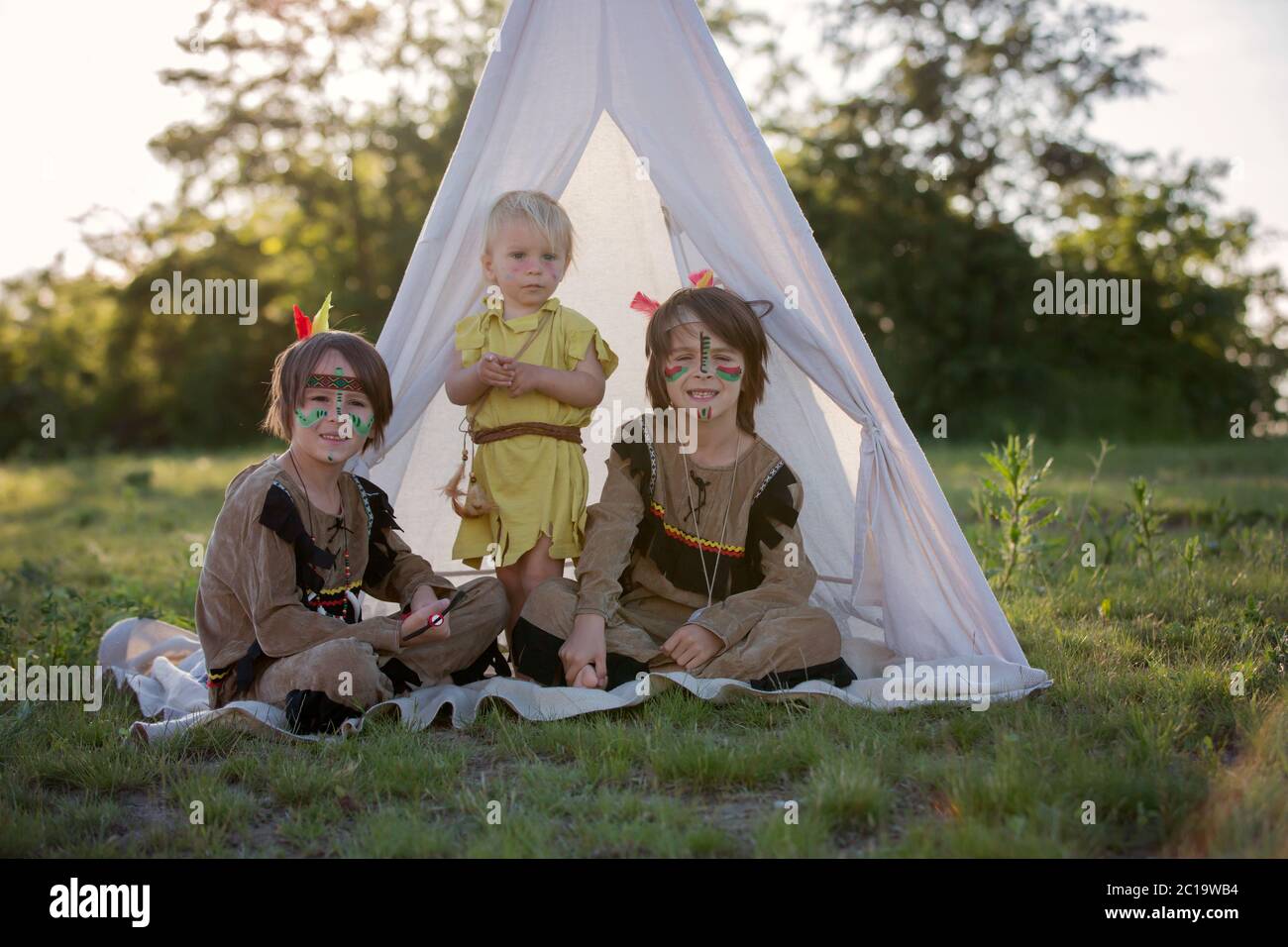 Cute portrait of native american boys with costumes, playing outdoor in ...