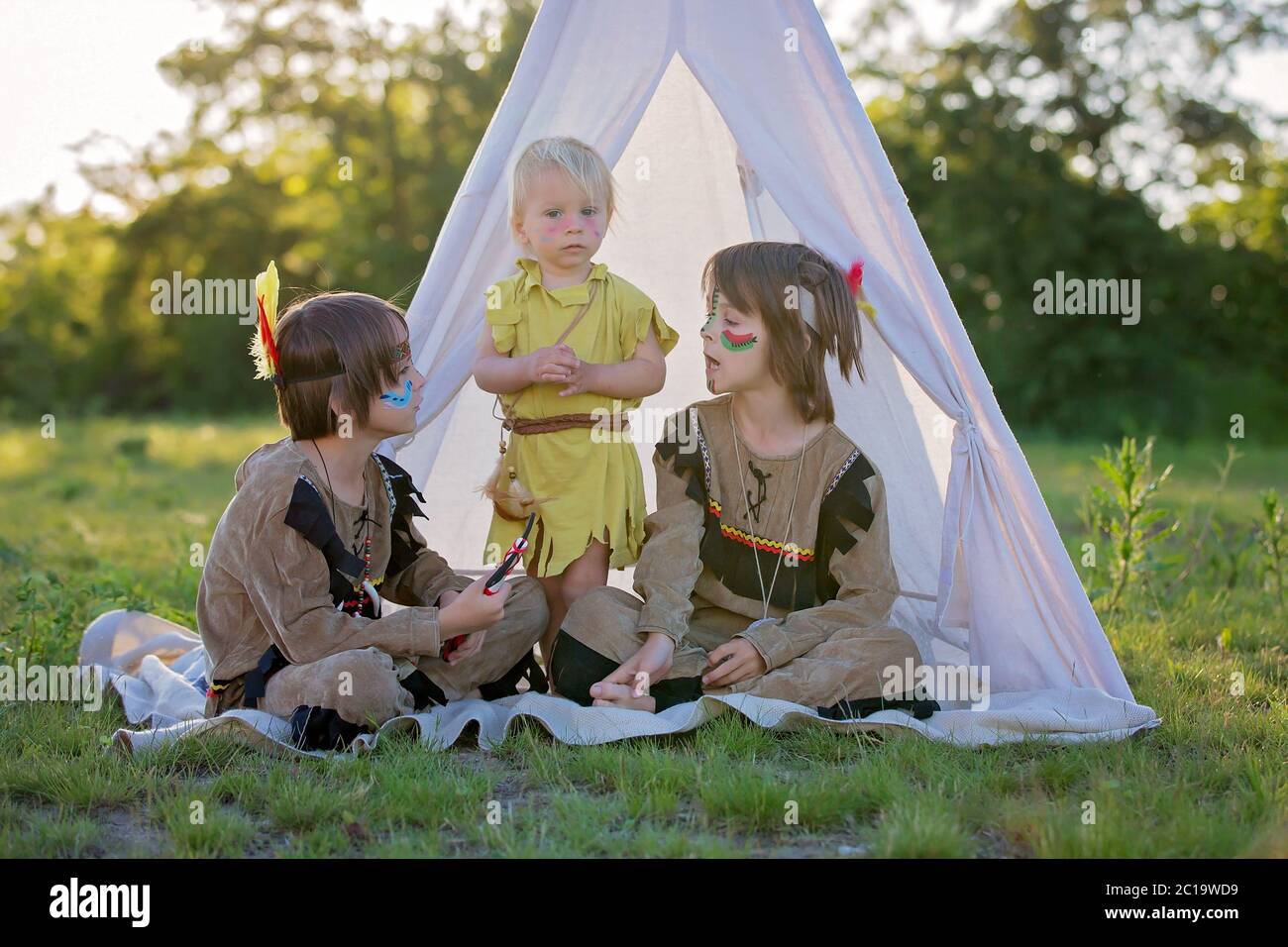 Cute portrait of native american boys with costumes, playing outdoor in ...