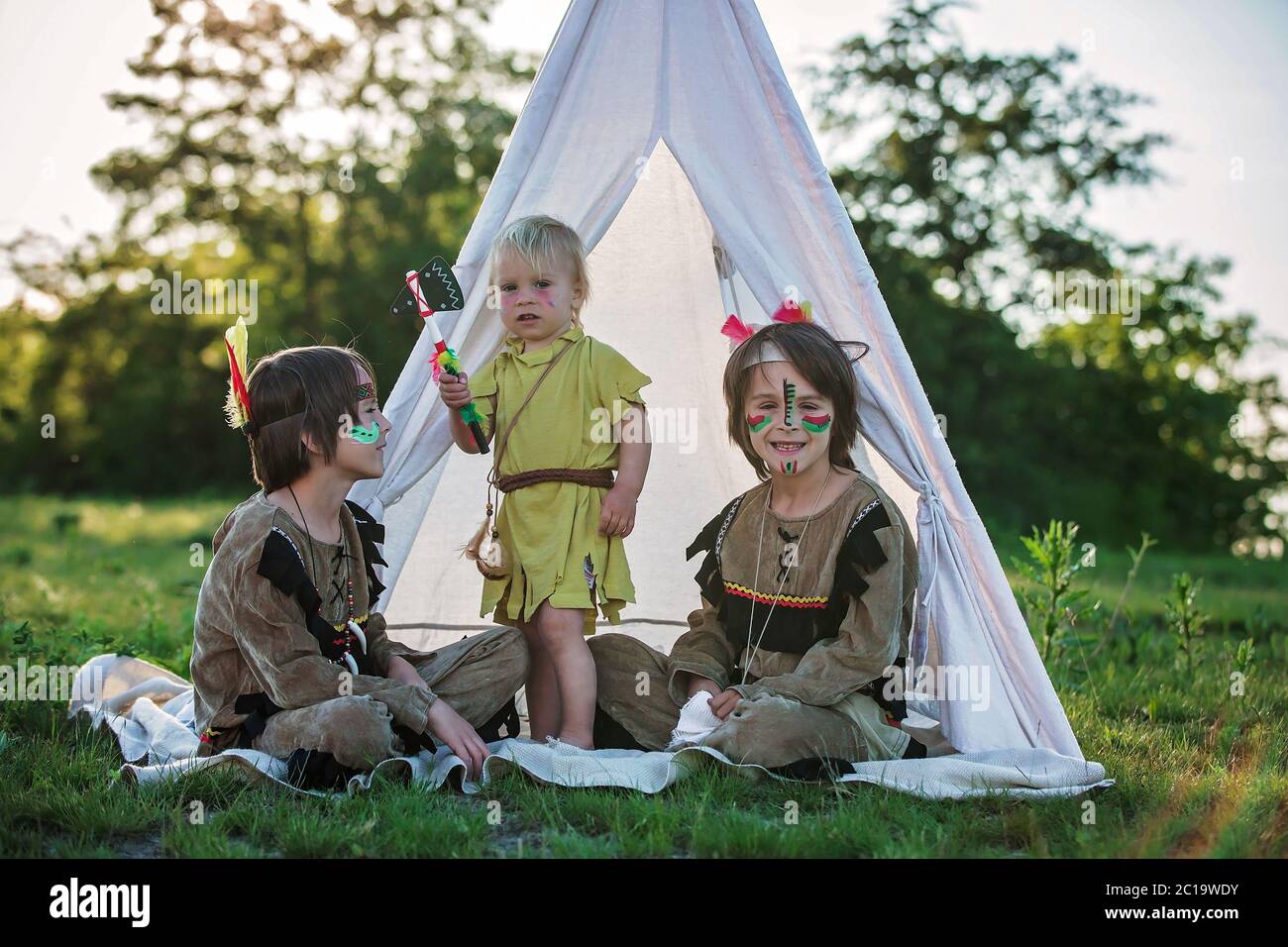 Cute portrait of native american boys with costumes, playing outdoor in ...