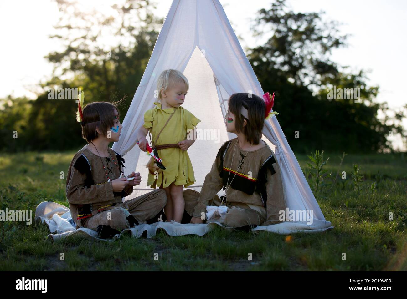 Cute portrait of native american boys with costumes, playing outdoor in ...