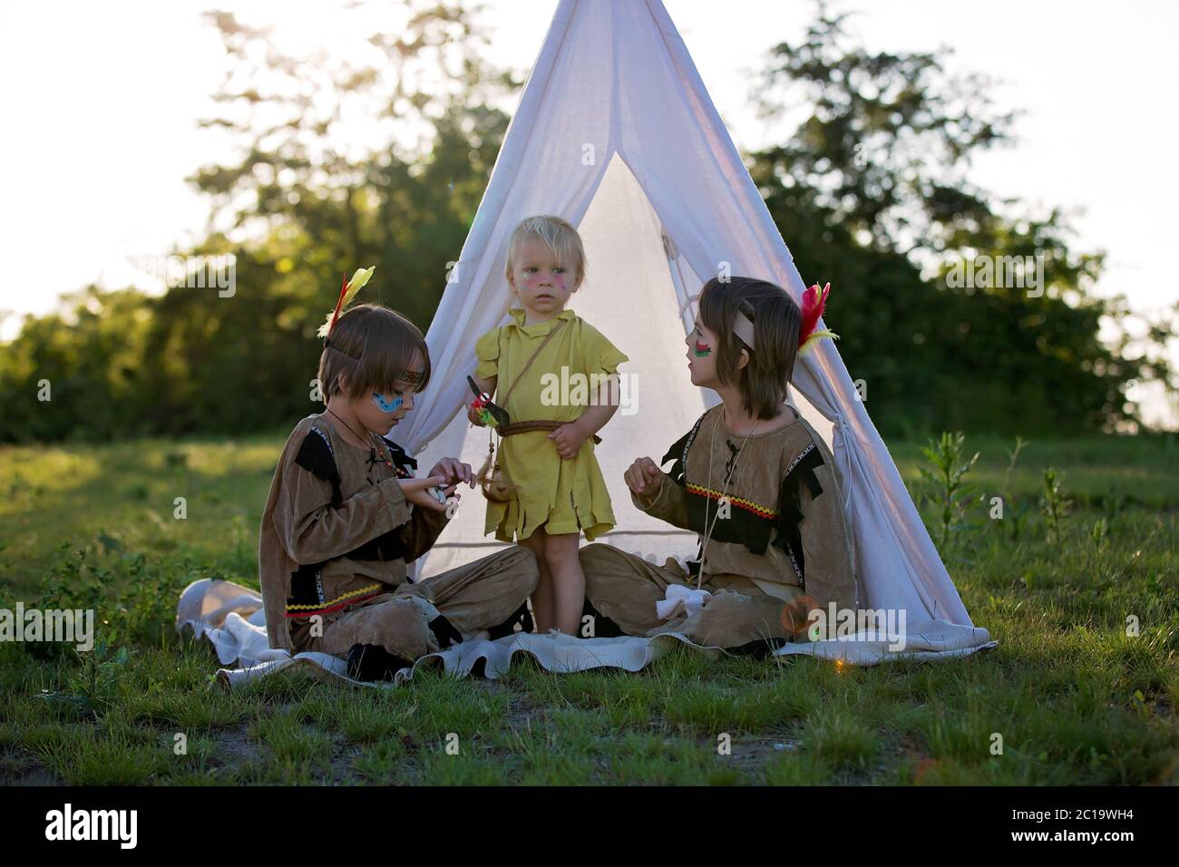Cute portrait of native american boys with costumes, playing outdoor in ...