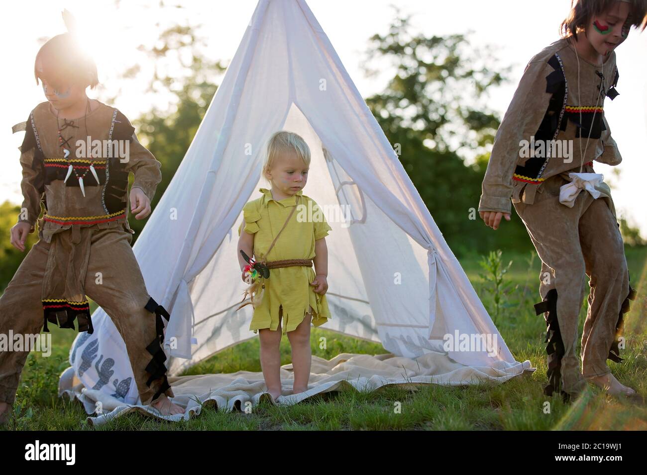 Cute portrait of native american boys with costumes, playing outdoor in ...