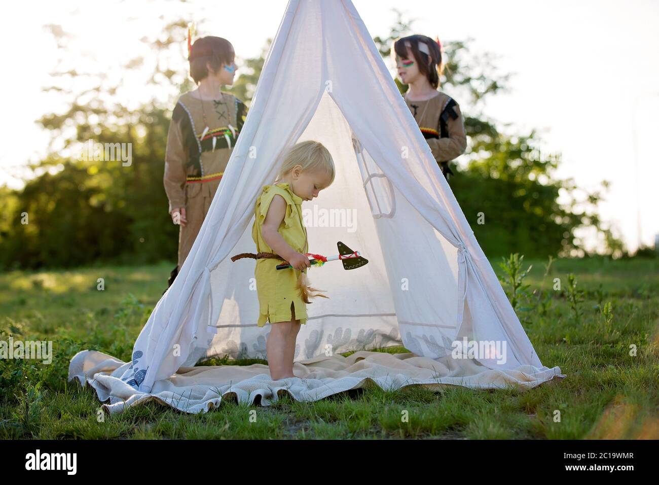 Cute portrait of native american boys with costumes, playing outdoor in ...