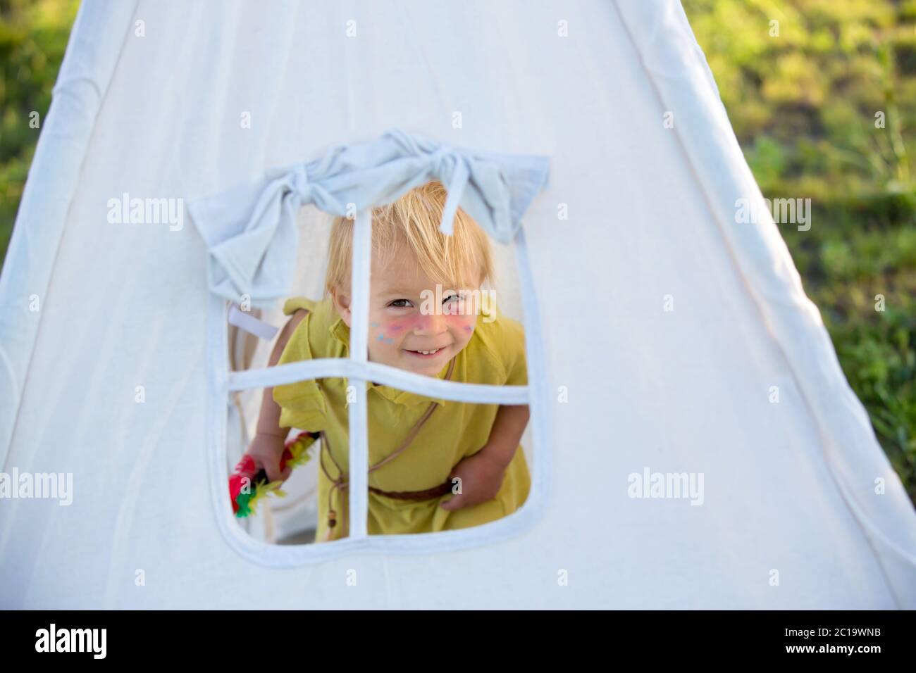 Cute portrait of native american boys with costumes, playing outdoor in ...