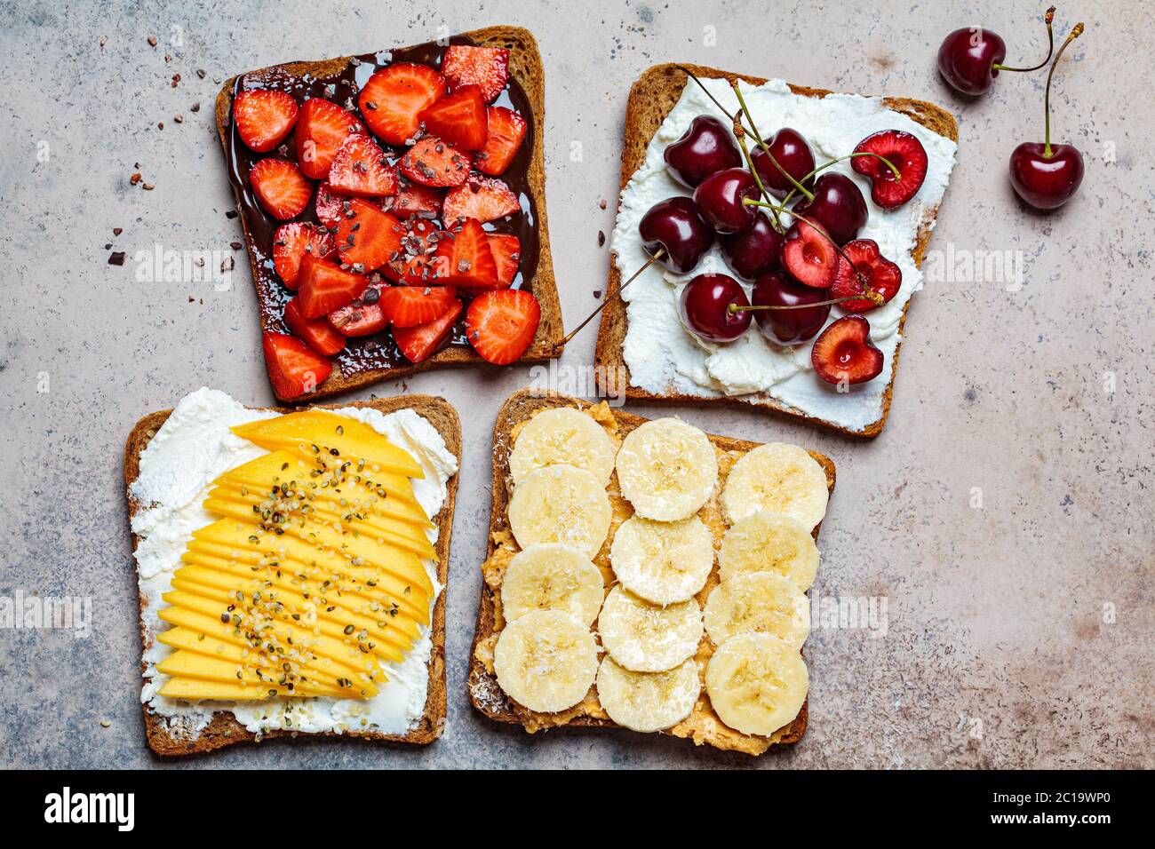 Different sweet fruit toasts with banana, mango, cherry and ...