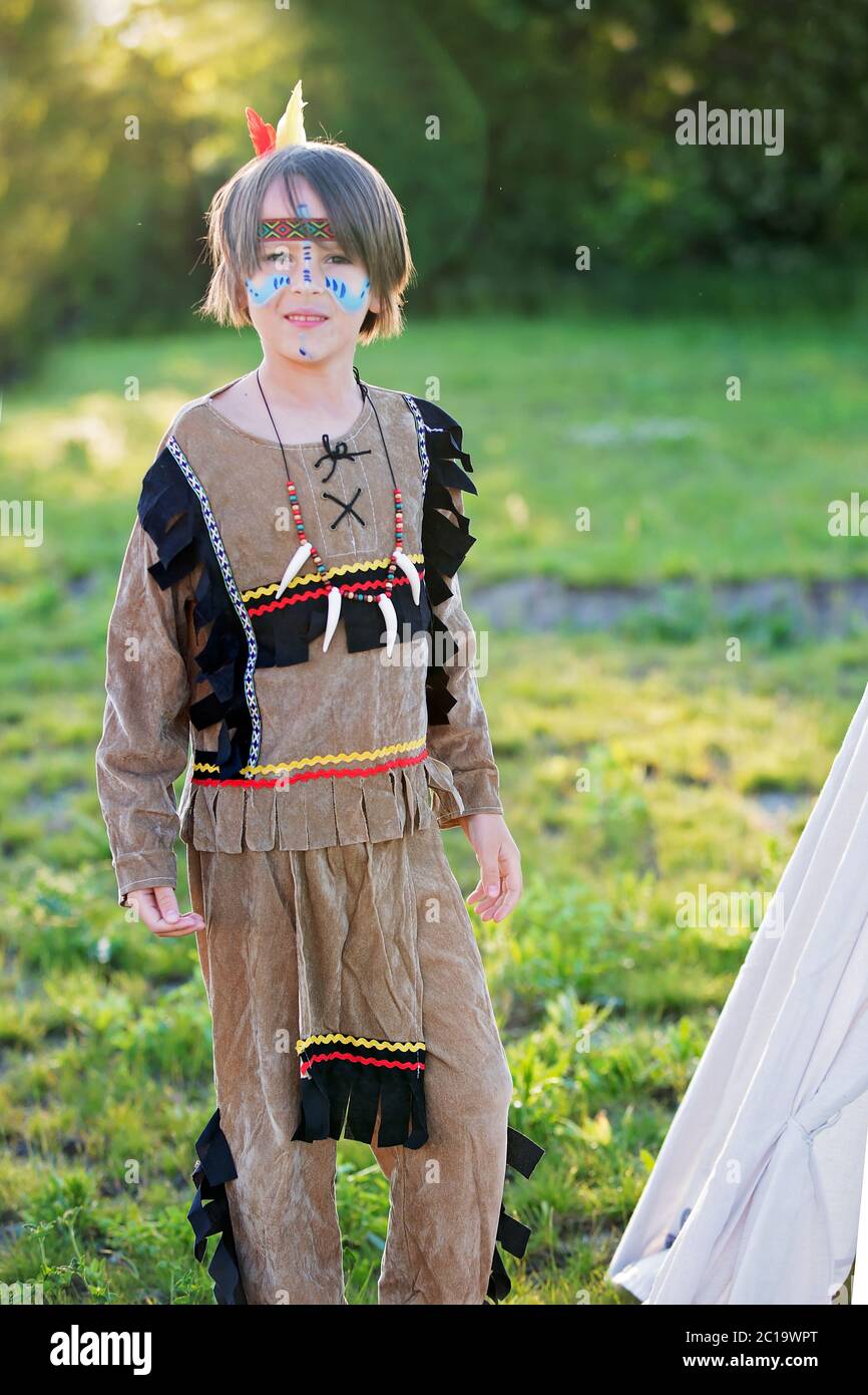 Cute portrait of native american boys with costumes, playing outdoor in ...