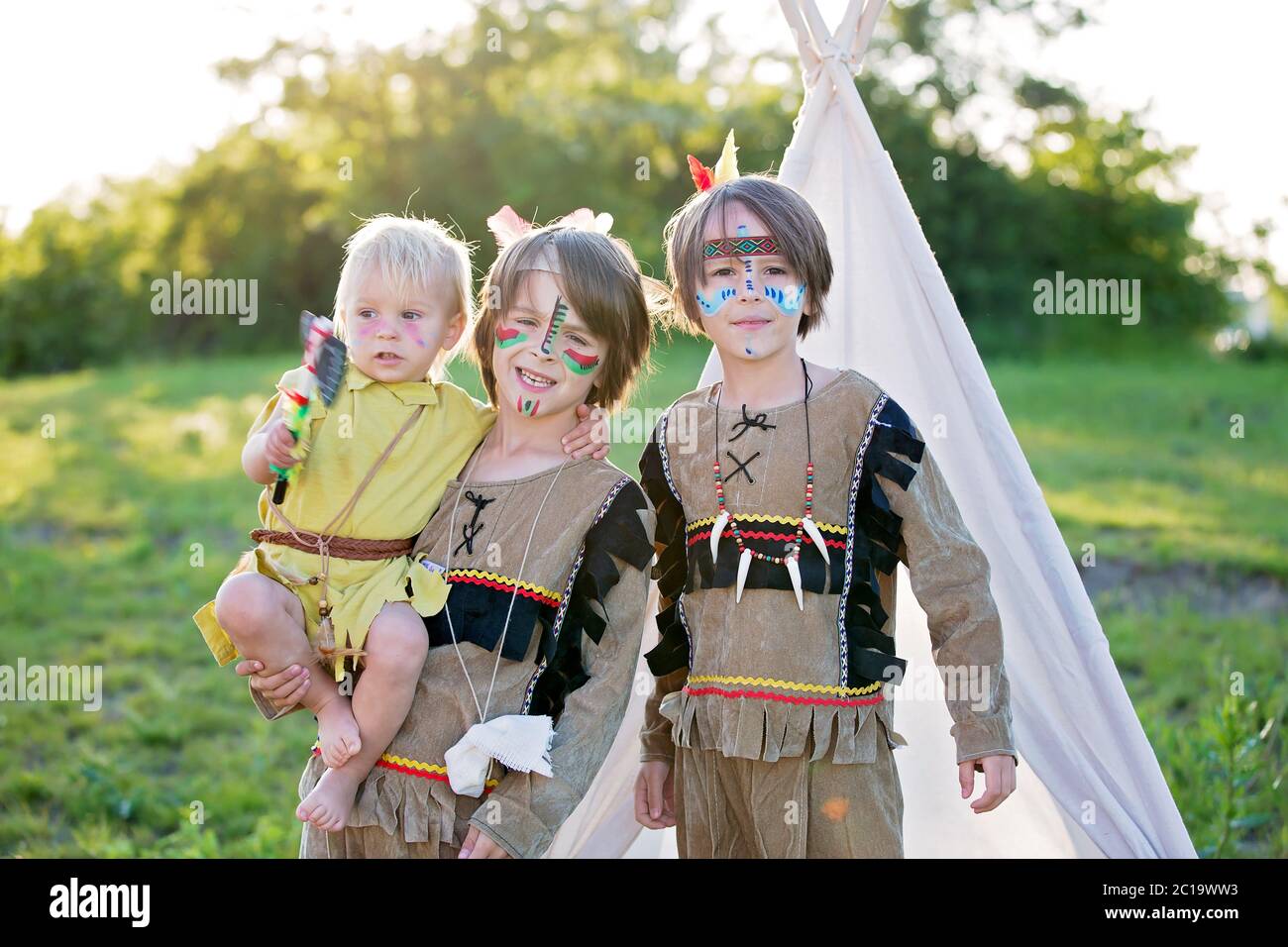 Cute portrait of native american boys with costumes, playing outdoor in ...
