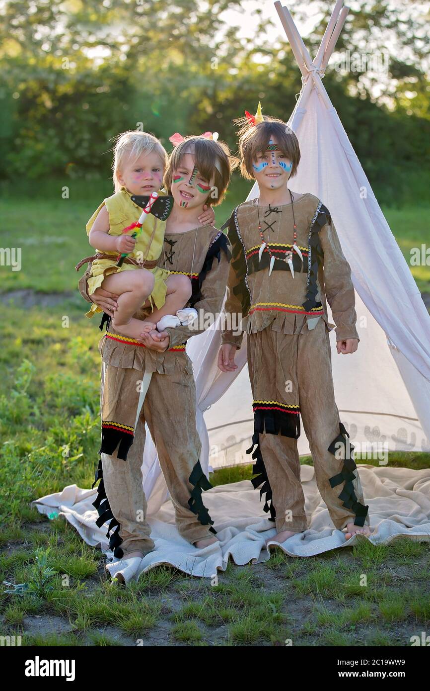 Cute portrait of native american boys with costumes, playing outdoor in ...