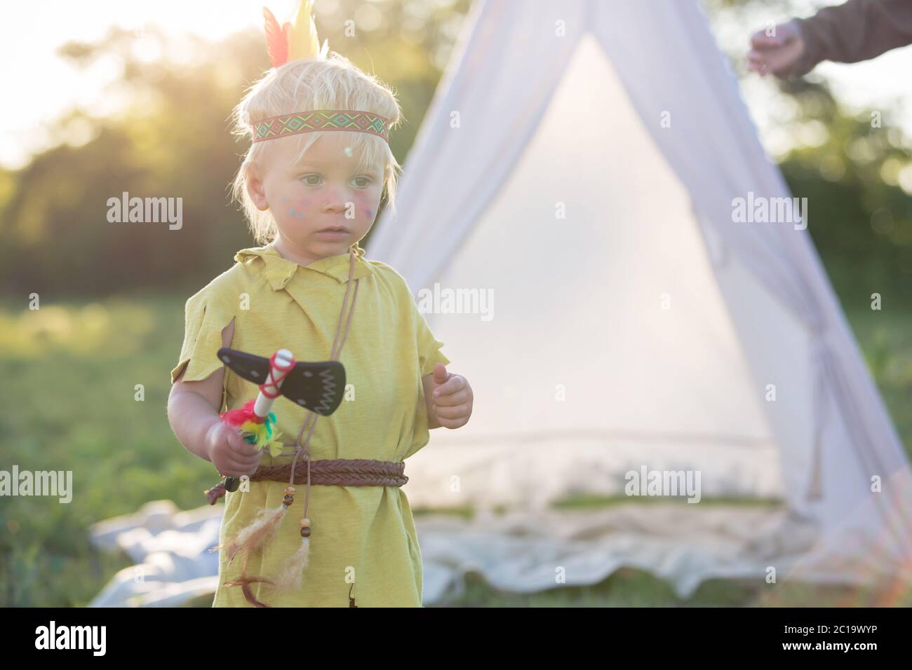 Cute portrait of native american boys with costumes, playing outdoor in ...
