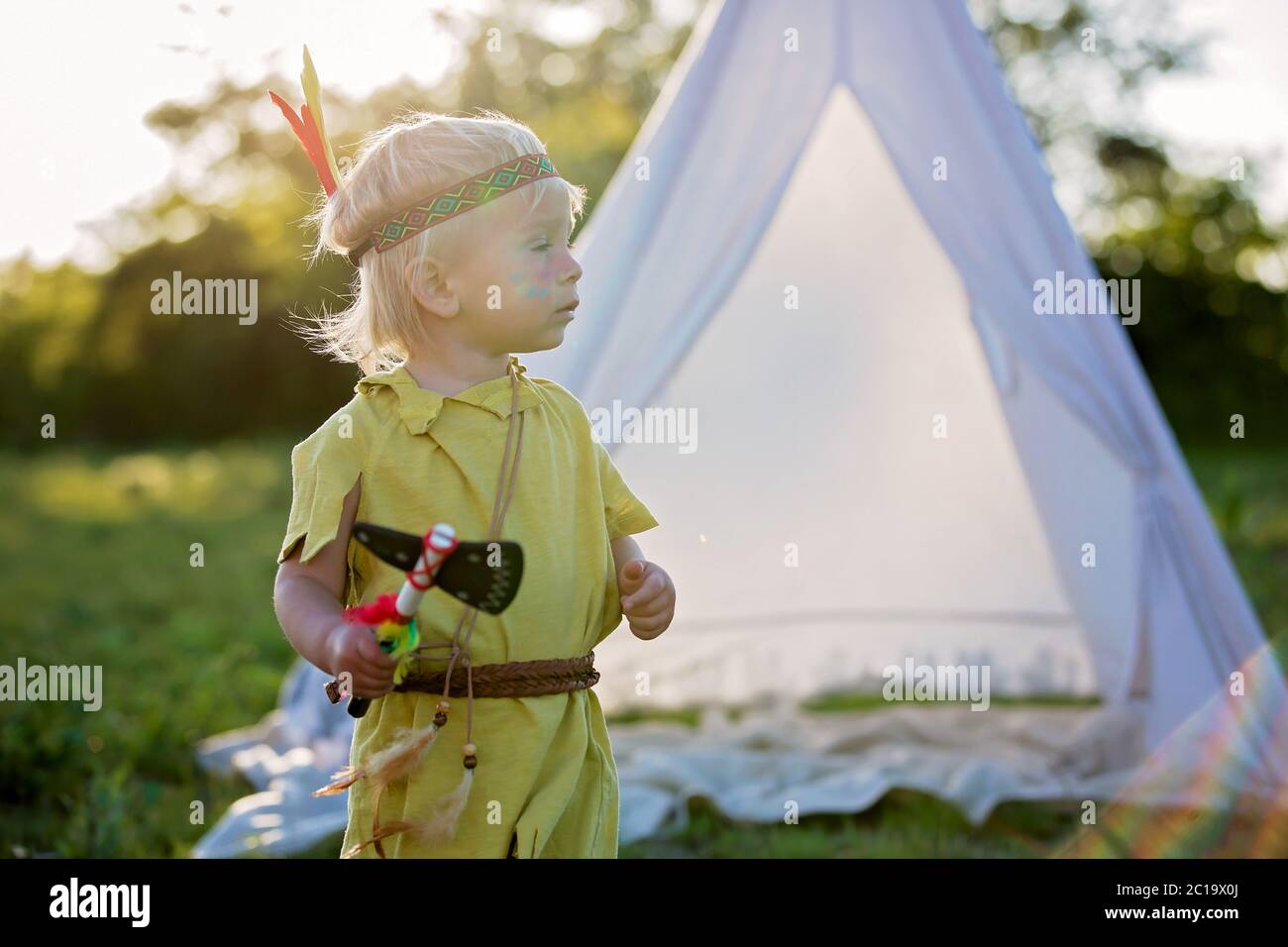 Cute portrait of native american boys with costumes, playing outdoor in ...