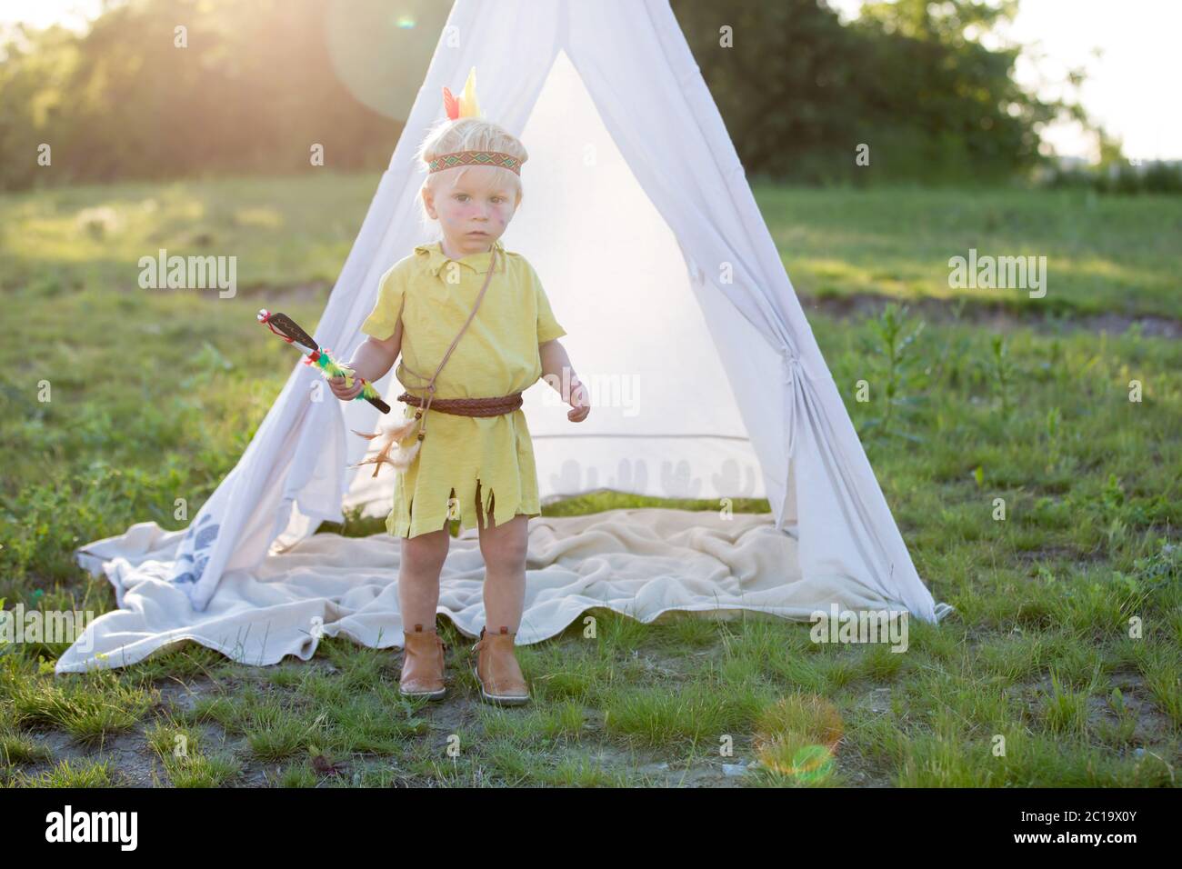 Cute portrait of native american boys with costumes, playing outdoor in ...