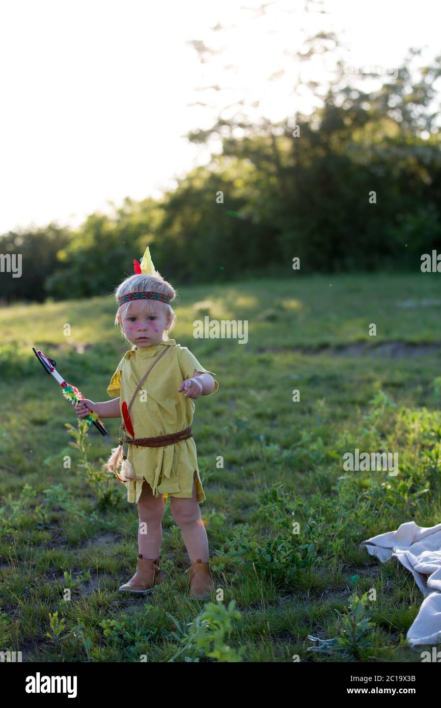 Cute portrait of native american boys with costumes, playing outdoor in ...
