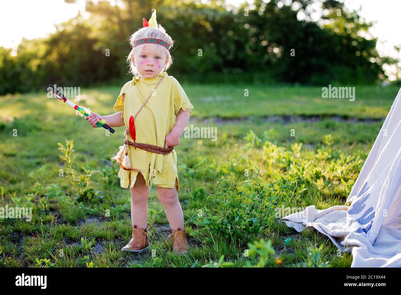Cute portrait of native american boys with costumes, playing outdoor in ...
