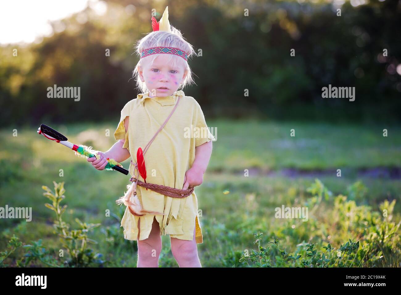 Cute portrait of native american boys with costumes, playing outdoor in ...
