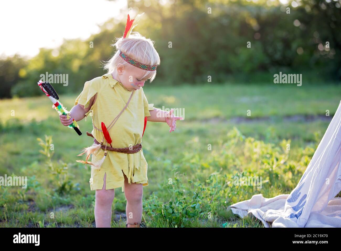 Cute portrait of native american boys with costumes, playing outdoor in ...