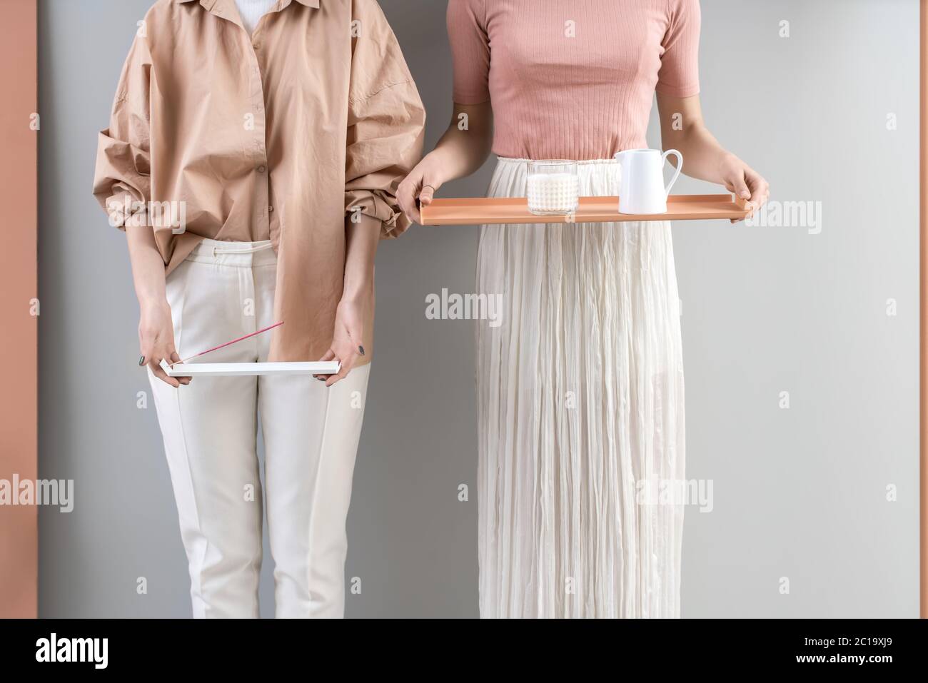 Girls holding tray and support Stock Photo - Alamy