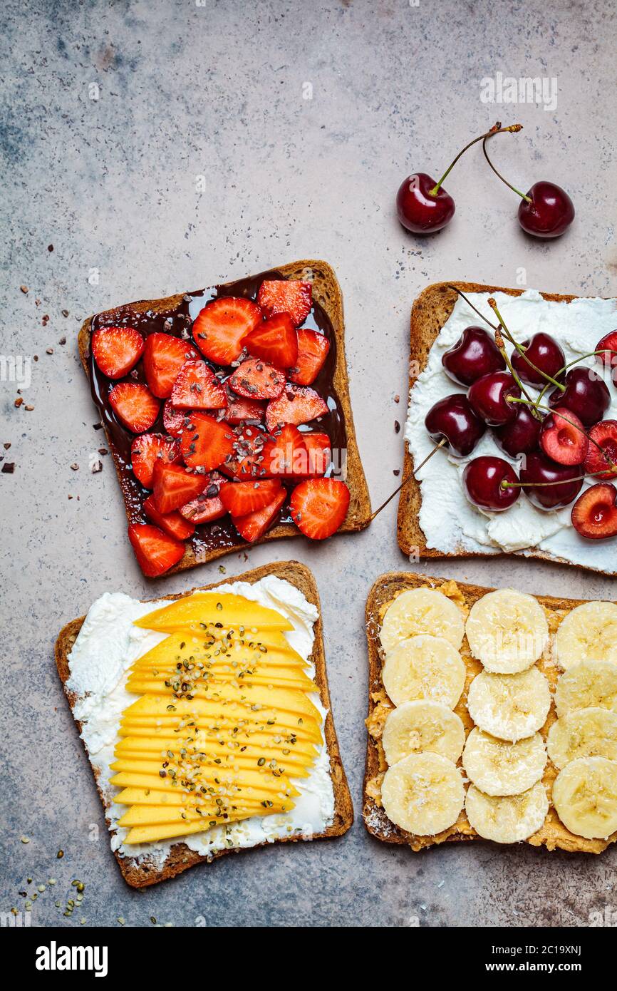 Different sweet fruit toasts with banana, mango, cherry and ...