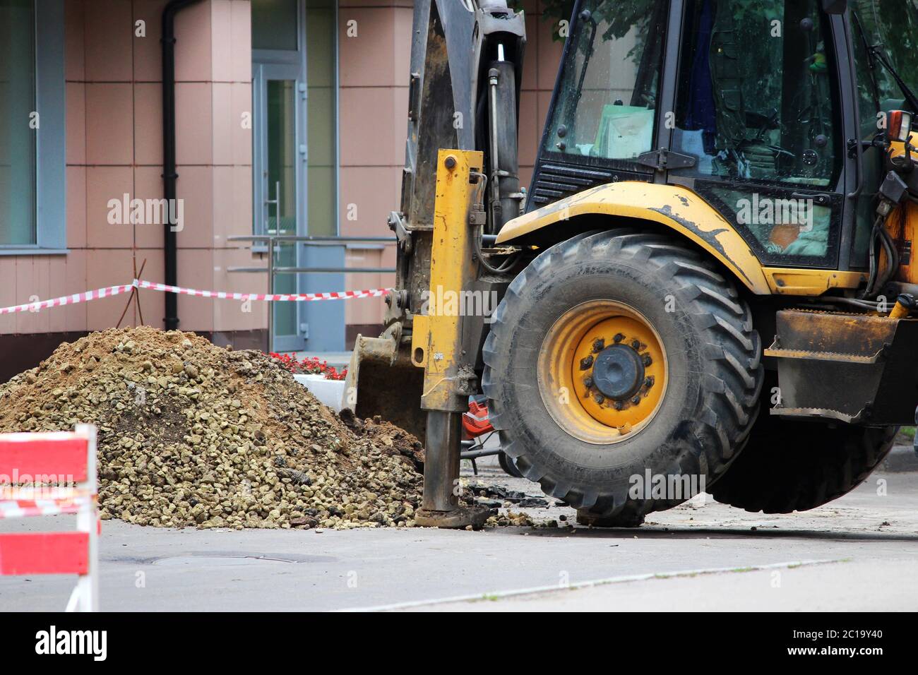 Tractor strong outrigger stabilizing legs extended to stabilize and ...