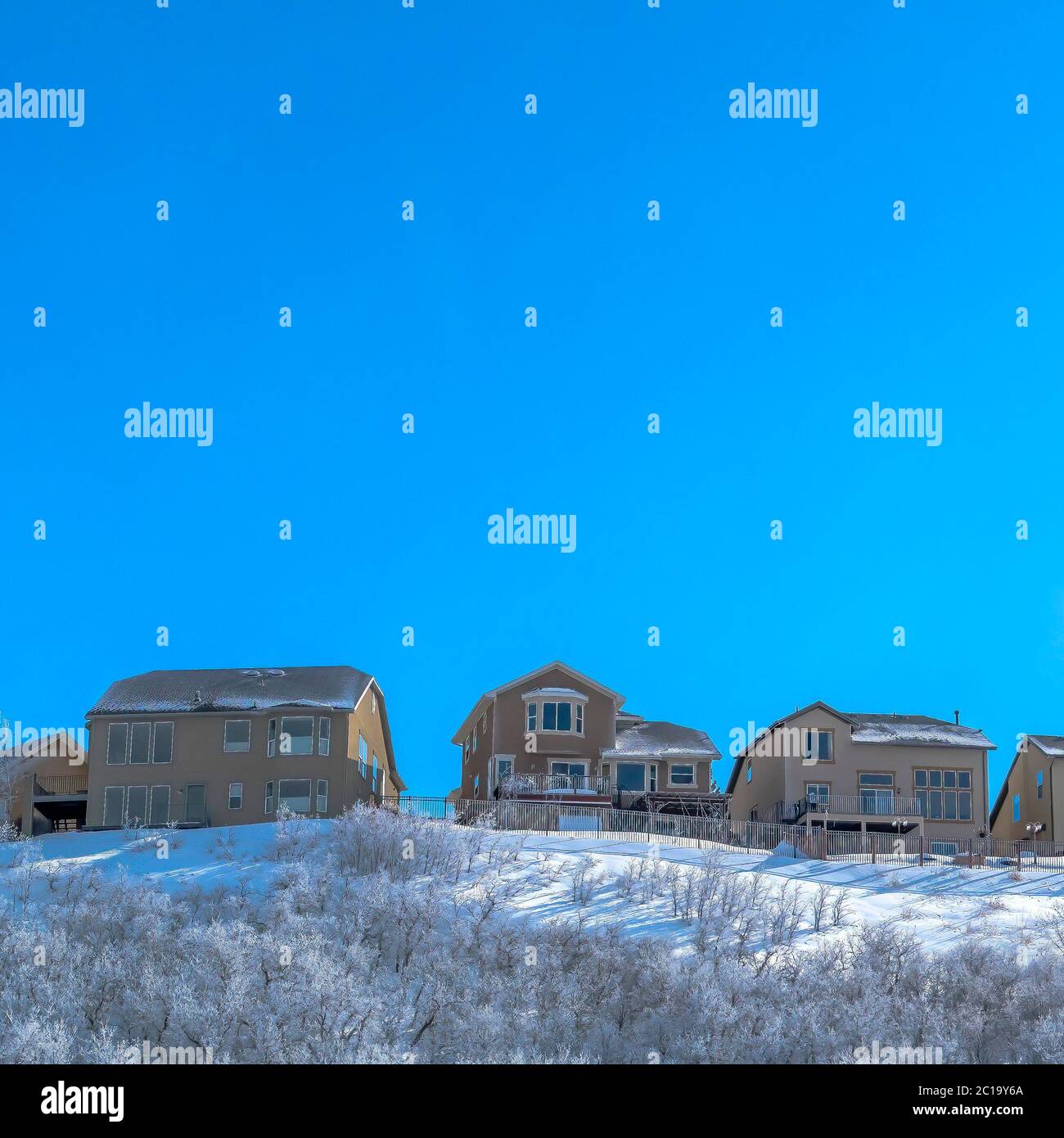 Square Row of houses on a neighborhood at the snowy terrain of Wastch ...
