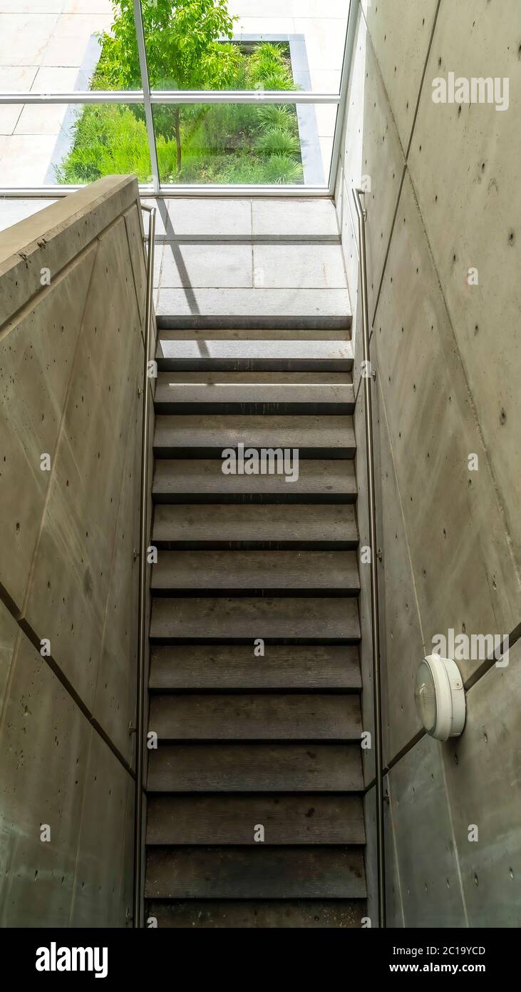 Vertical crop View from above of concrete stairway with metal handrails ...