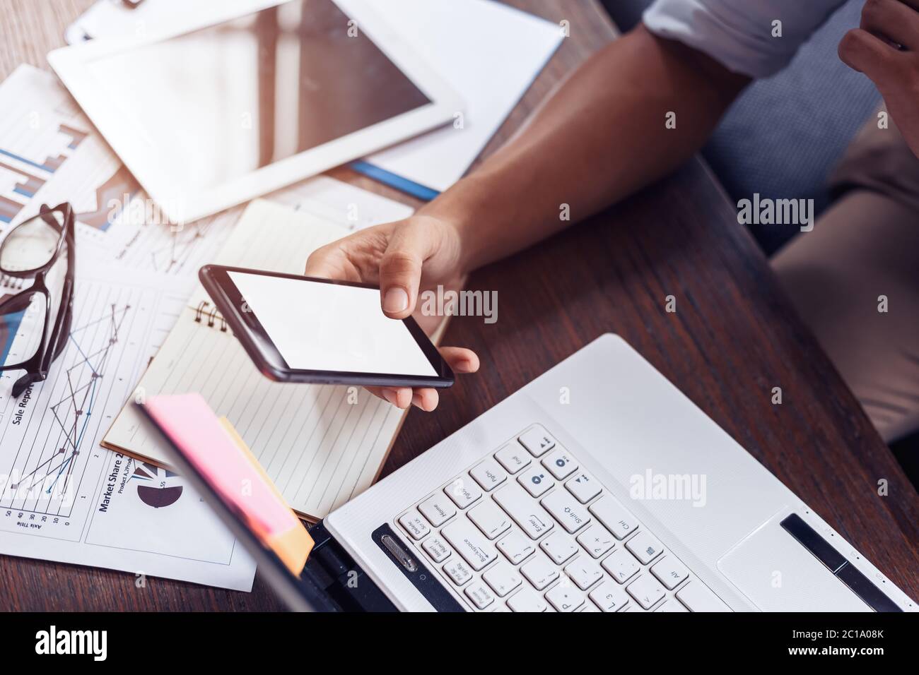 Businessman use mobile phone for working and check message. Laptop ...