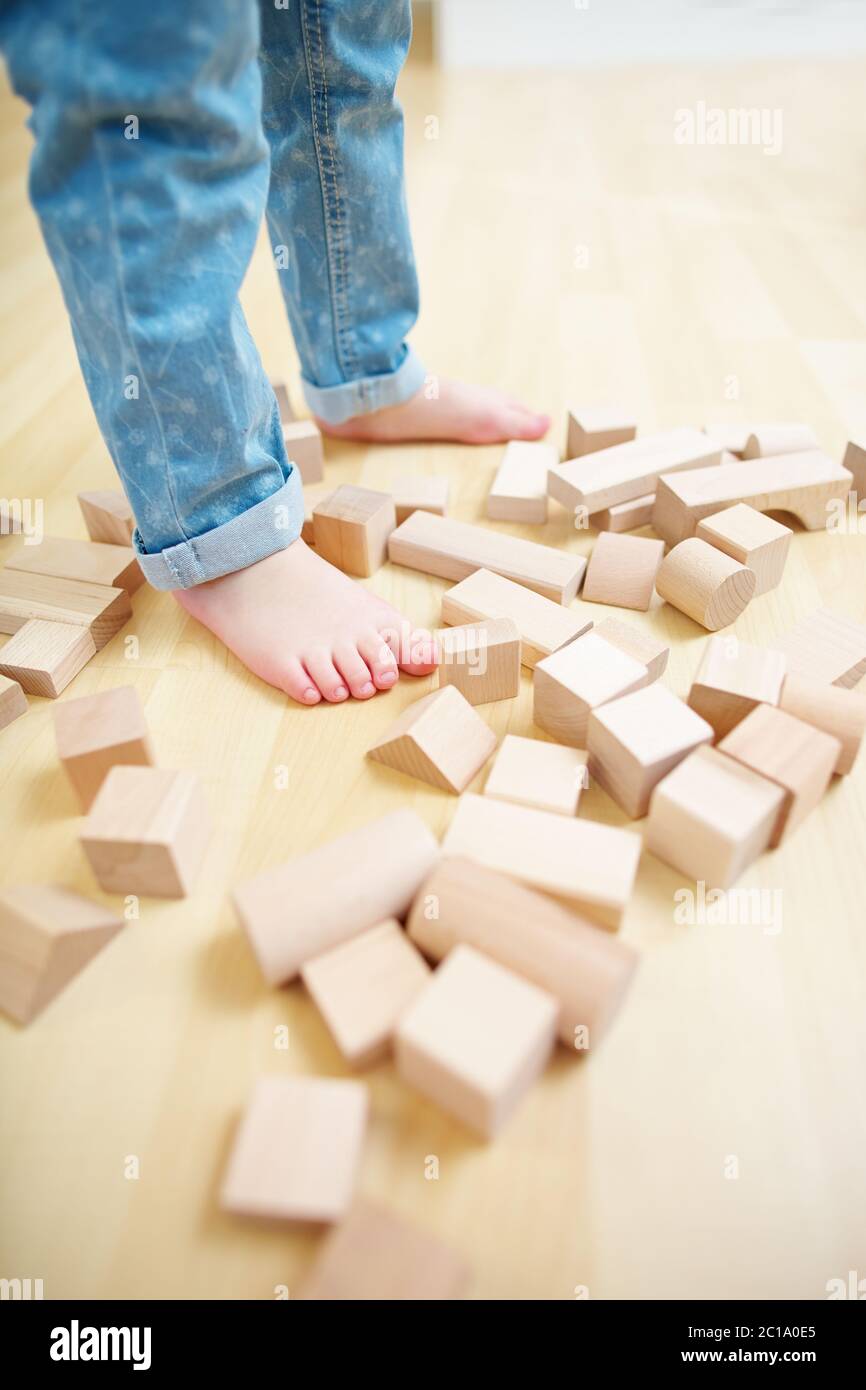 Building blocks lie on the floor at the feet of a child Stock Photo - Alamy