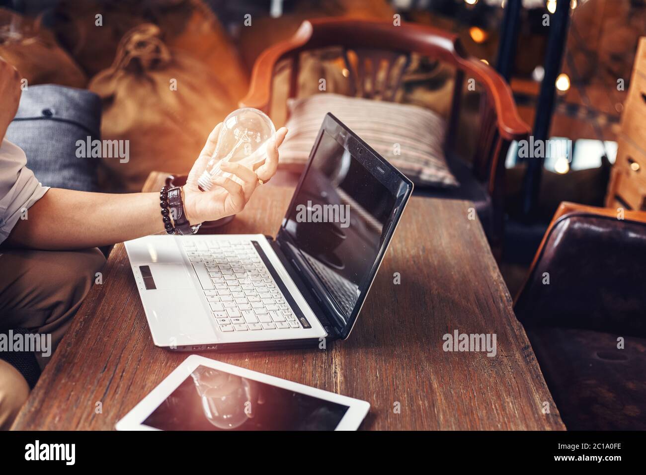 Light blub on businessman hands. Idea, strategy and success concept ...