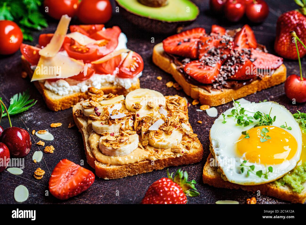 Breakfast different toasts with berries, cheese, egg and fruit, dark ...