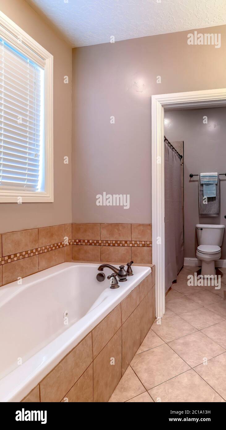 Vertical Bathroom interior with bathtub double sink vanity mirror ...
