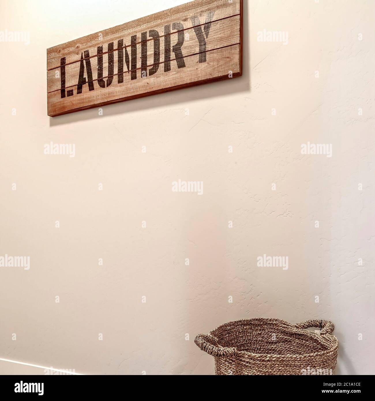 Square Laundry room interior with woven basket and decorative wooden ...